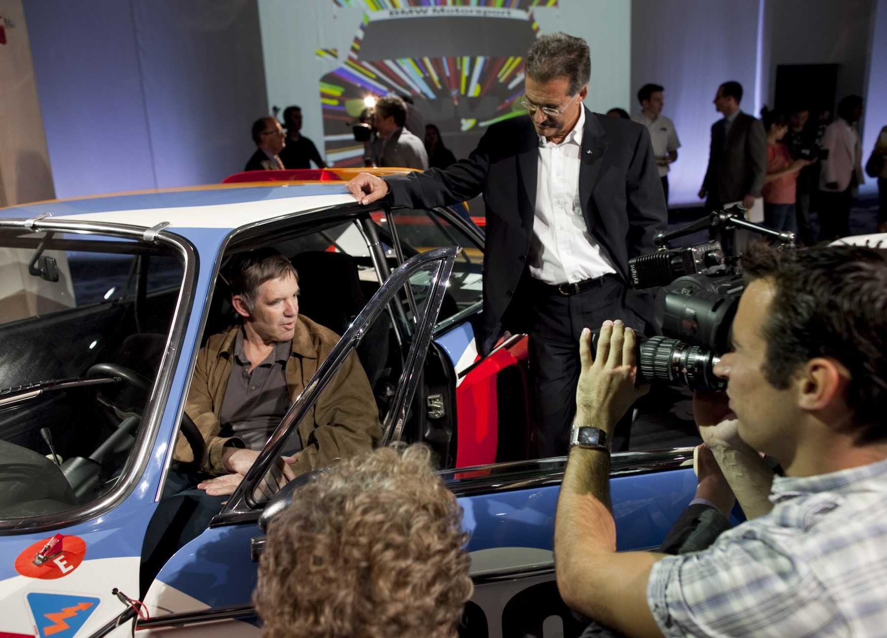 Race car driver Sam Posey seated in the Alexander Calder Art Car ...